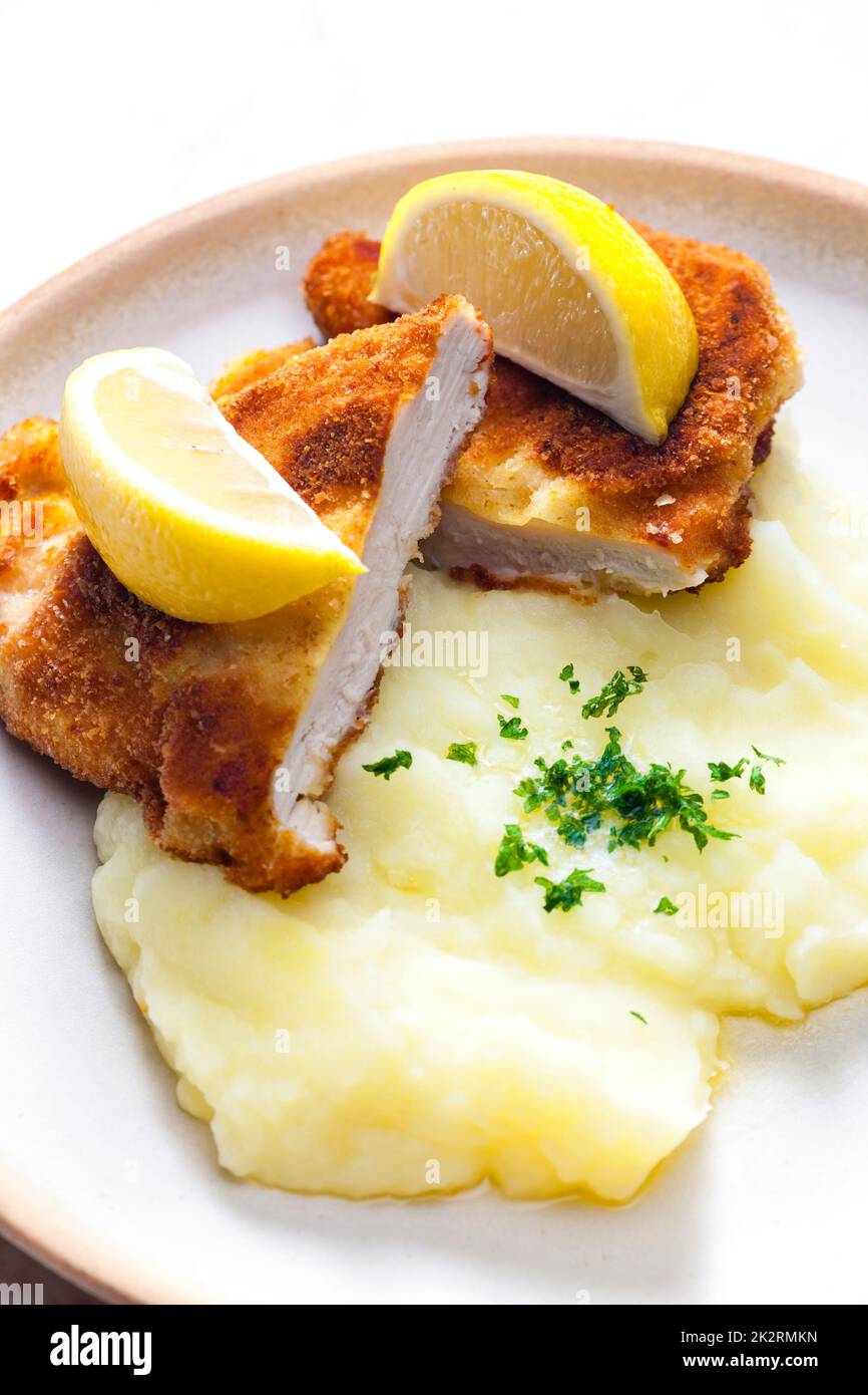 chicken schnitzel with mashed potatoes and lemon Stock Photo - Alamy
