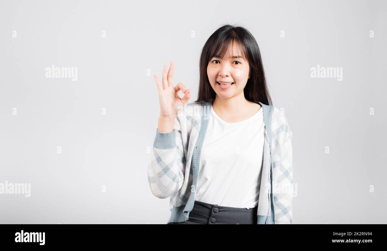 Woman smiling showing made finger OK symbol sign to agree Stock Photo ...
