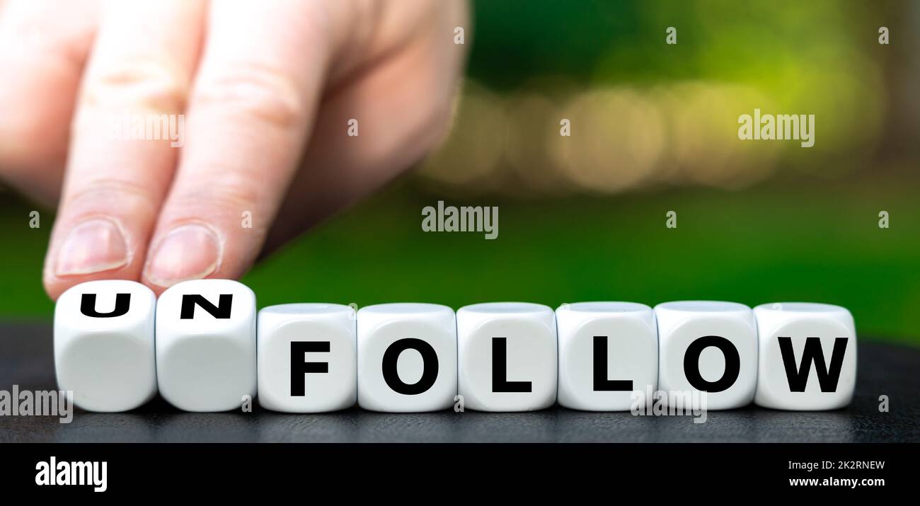 Hand turns dice and changes the expression "follow" to "un follow Stock ...