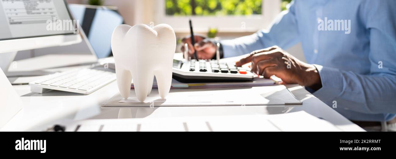 White Tooth In Front Of Man Calculating Bill Stock Photo - Alamy