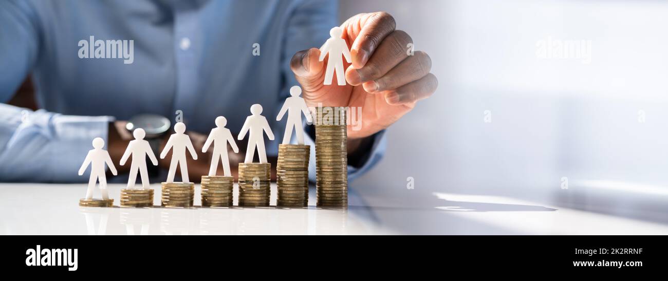 Human Hand Placing Human Figure On Increasing Stacked Coins Stock Photo ...
