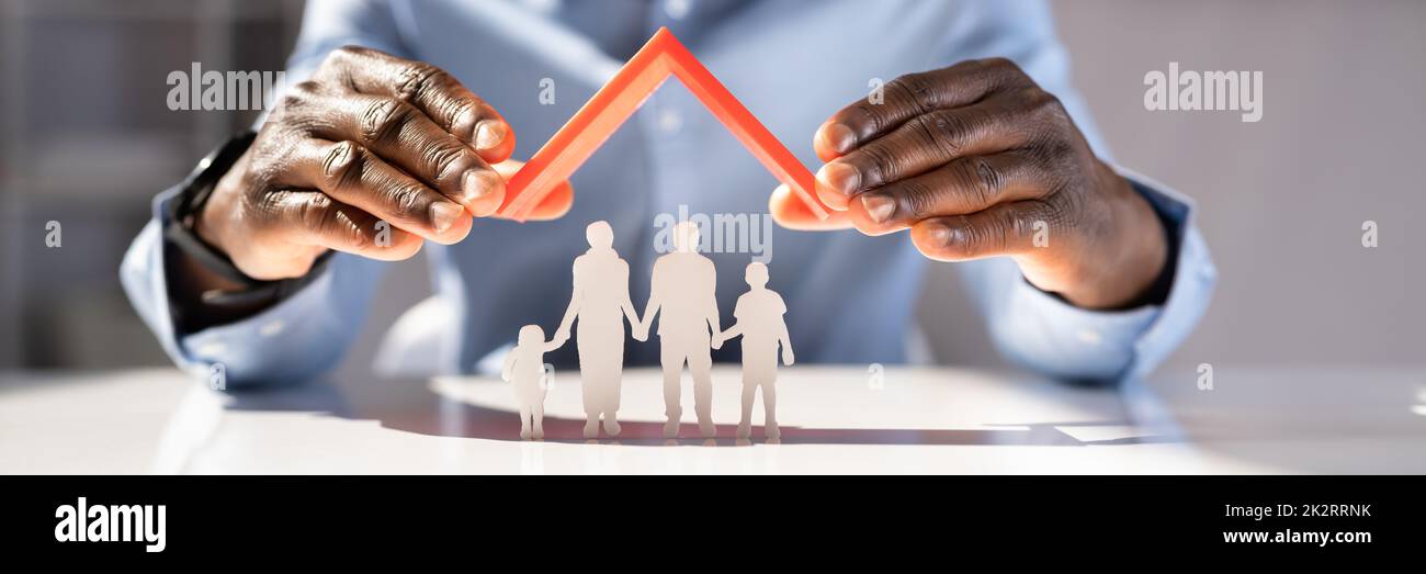 Person Protecting Family Figures With Roof Stock Photo - Alamy