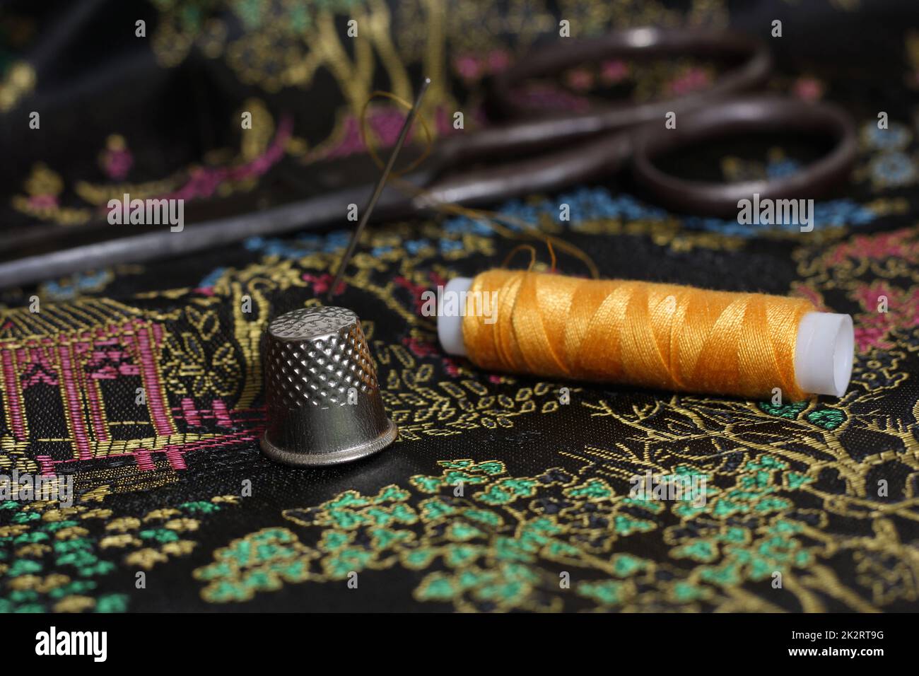 Yellow Thread and Thimble on Vintage Chinese Black Silk Stock Photo - Alamy