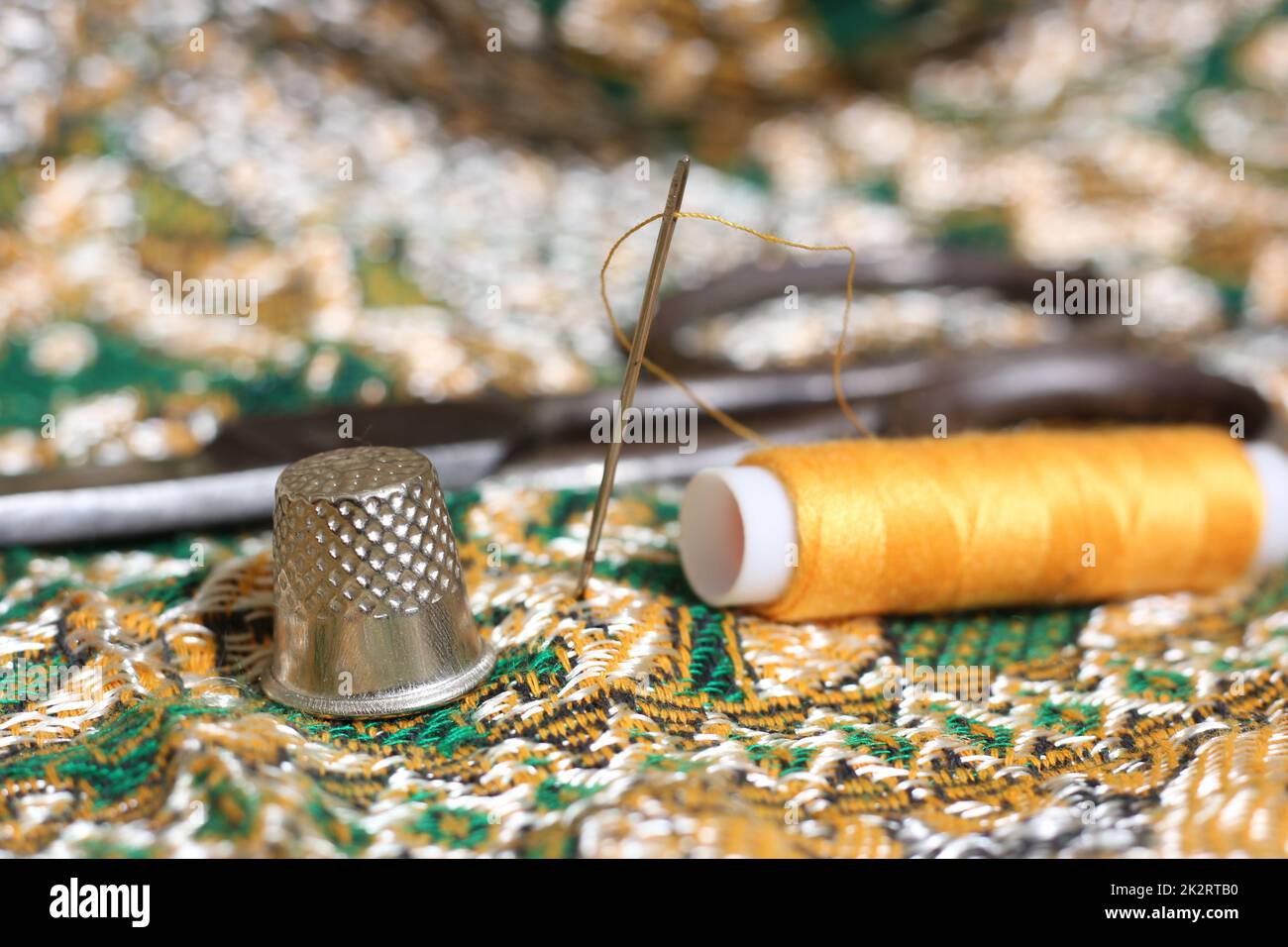 Golden Thread and Thimble on Vintage Fabric From The Middle East Stock ...