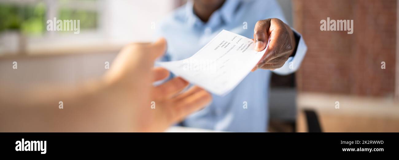 Businessman Giving Cheque To Colleague Stock Photo - Alamy