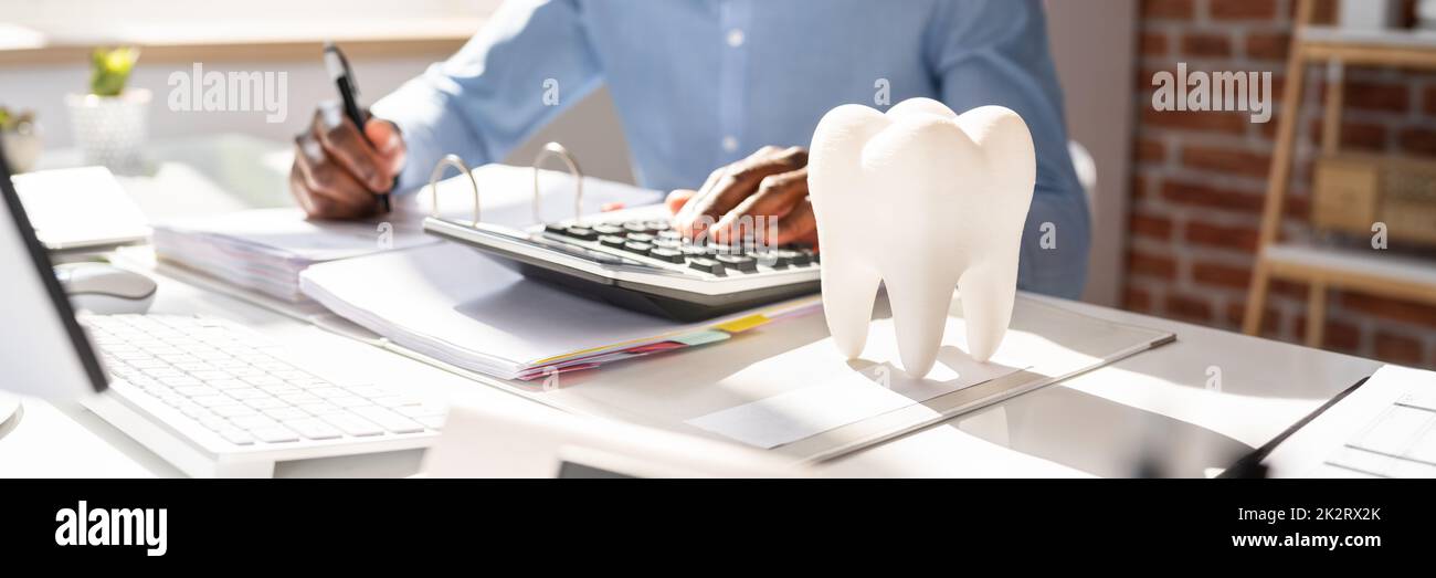 White Tooth In Front Of Man Calculating Bill Stock Photo - Alamy