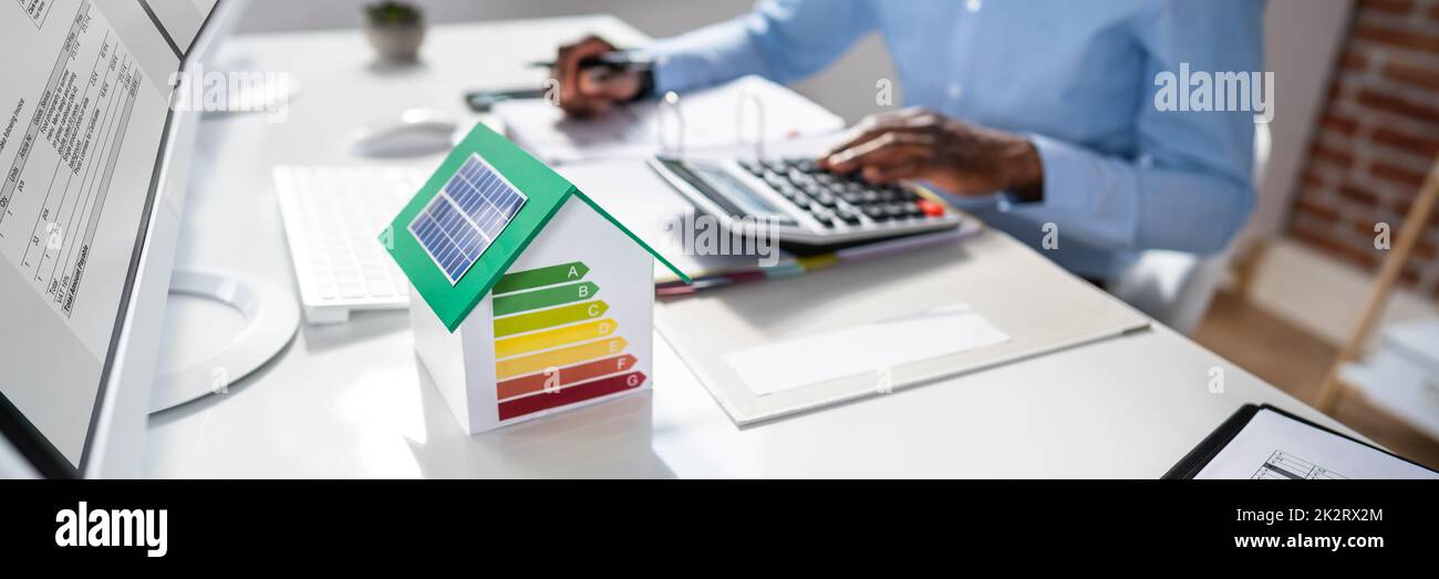 Businessman Calculating House Energy Cost Stock Photo - Alamy