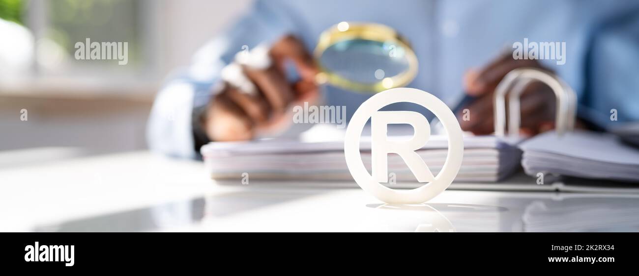 White Registered Trademark Sign Near Documents Stock Photo - Alamy