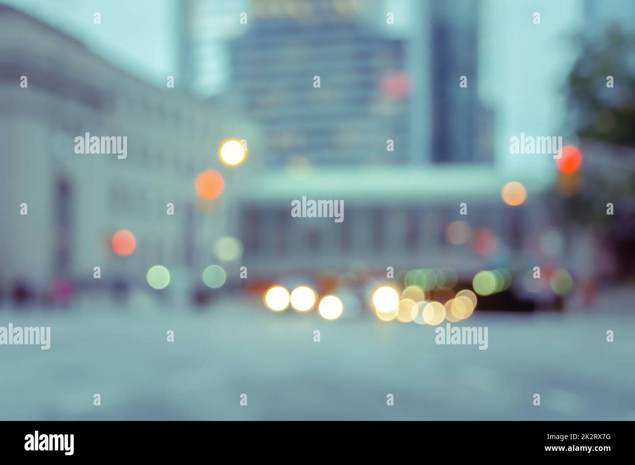Blurred city street with traffics light bokeh and buildings background ...
