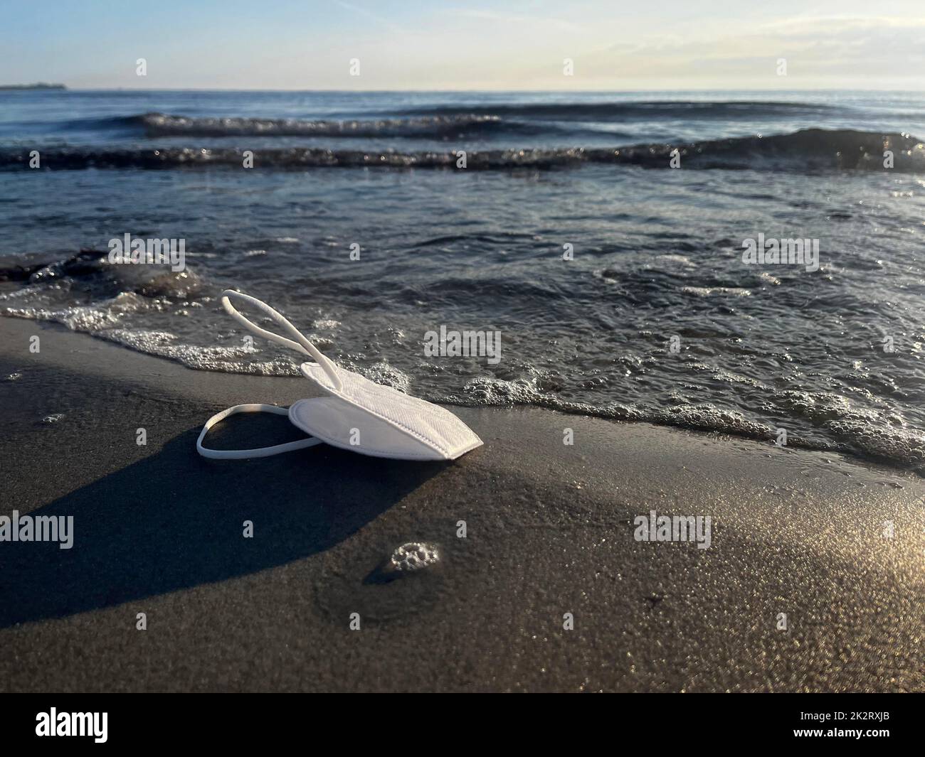 Vacation in times of Covid-19 with a mask on the beach Stock Photo - Alamy