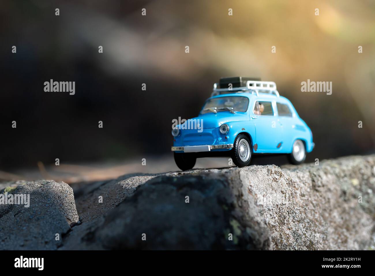 Miniature car on the road through the forest Stock Photo - Alamy