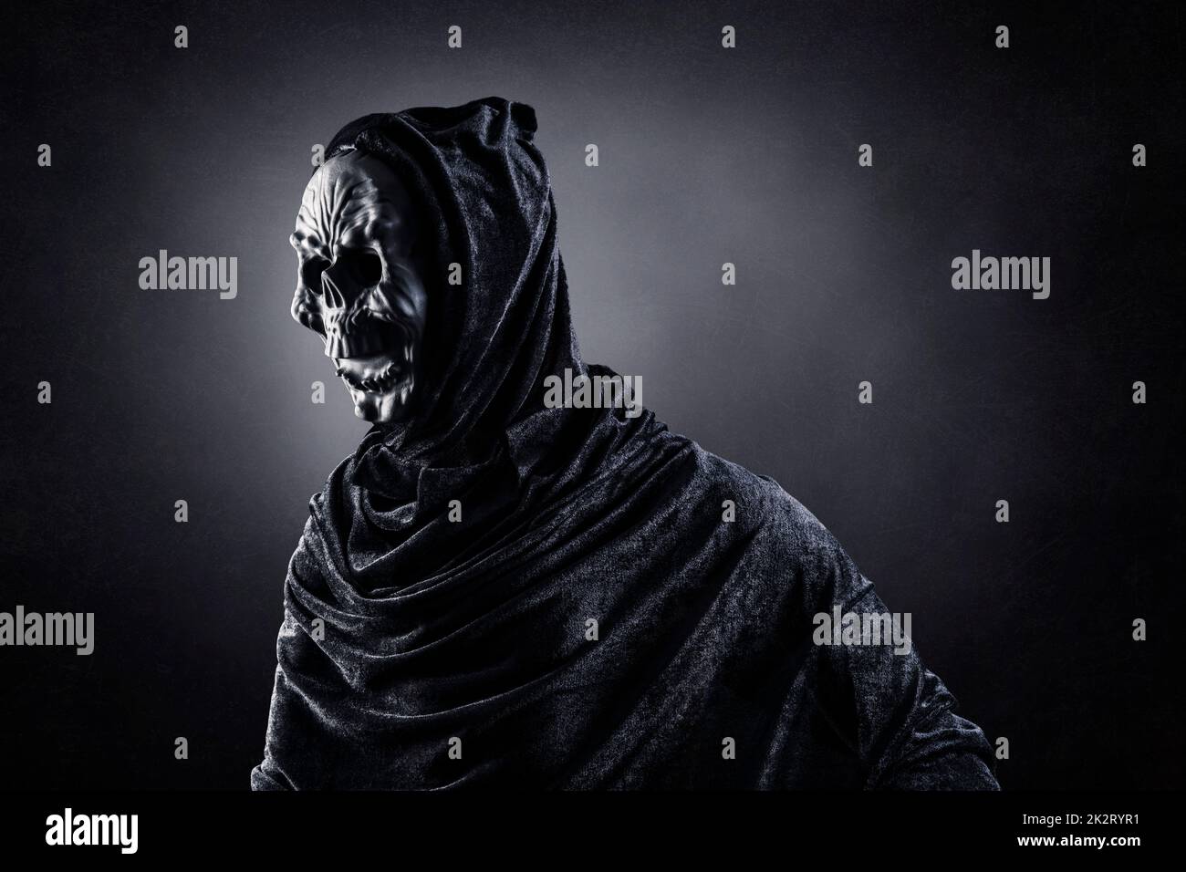 Grim reaper over dark misty background Stock Photo - Alamy