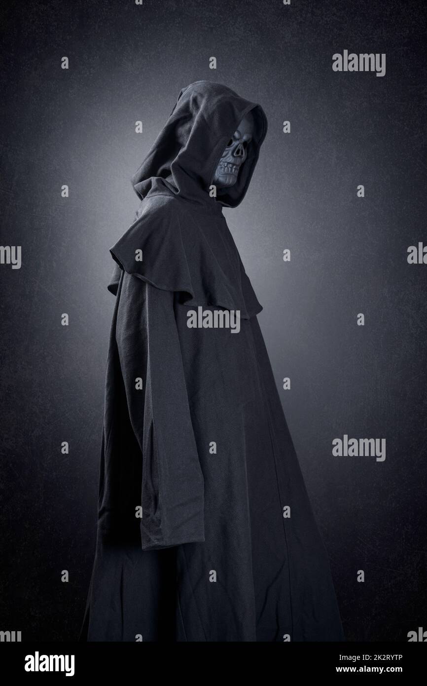 Grim reaper over dark misty background Stock Photo - Alamy