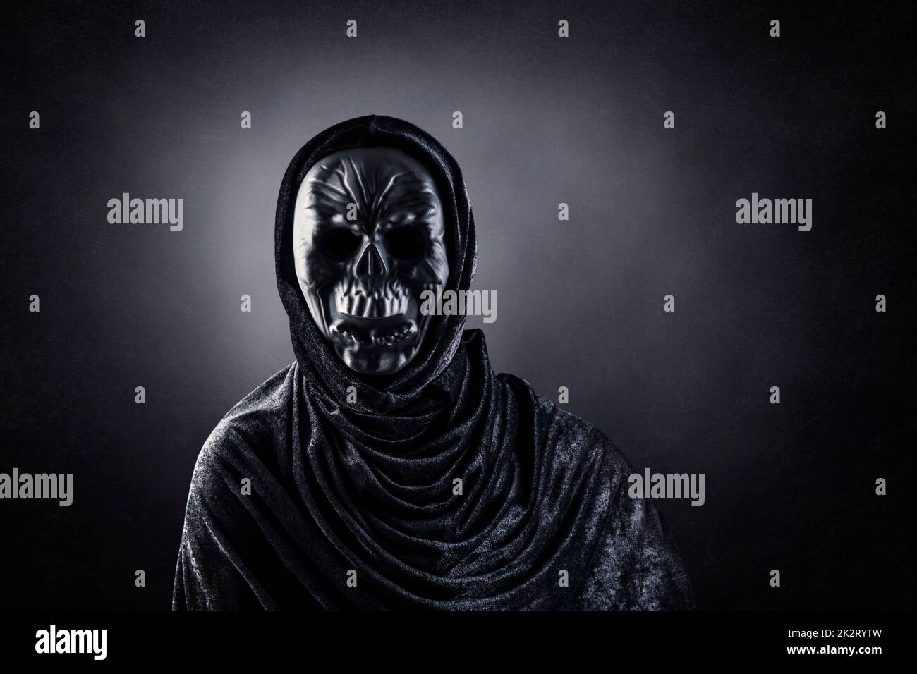 Grim reaper over dark misty background Stock Photo - Alamy