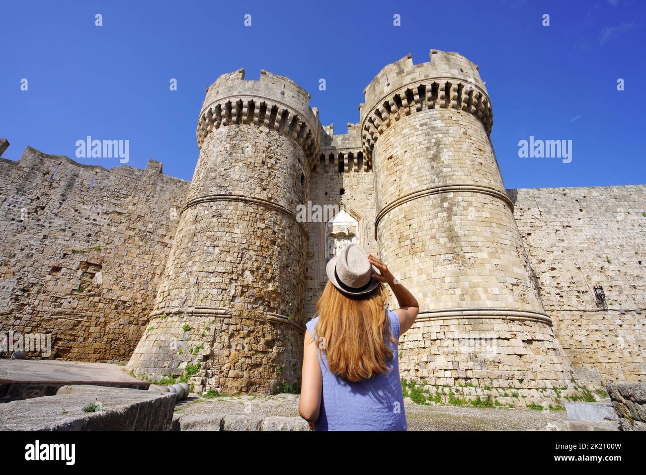 Tourism in Greece. Back view of tourist girl walking down the Marine ...