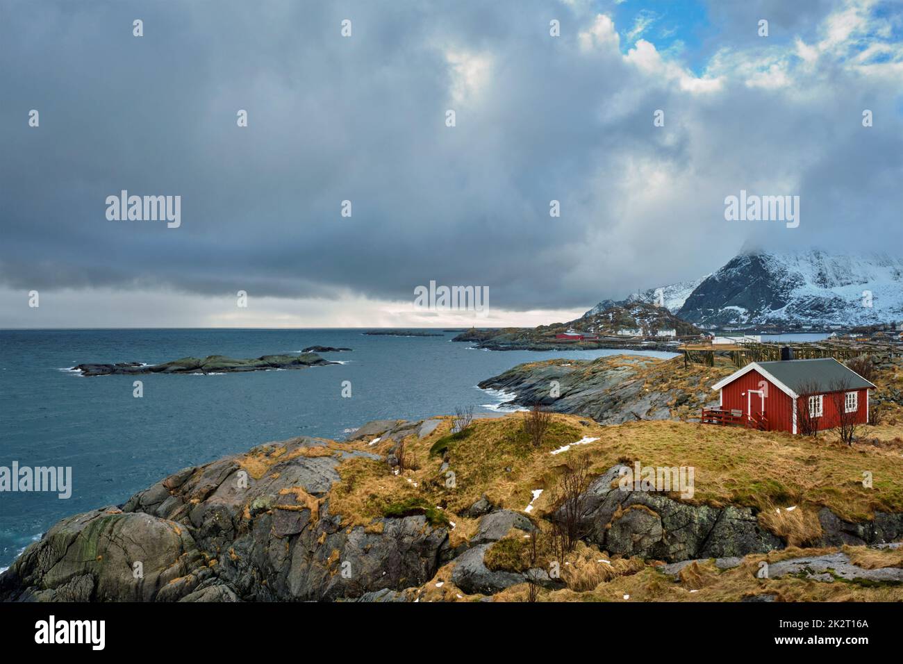 Clif with traditional red rorbu house on Lofoten Islands, Norway Stock ...