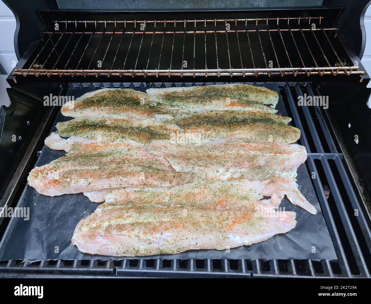 Grilled fish with spices on fire Stock Photo - Alamy