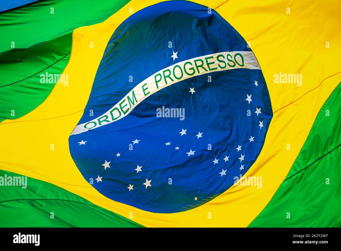 National flag of Brazil blowing on blue sky in Brasilia, South America ...