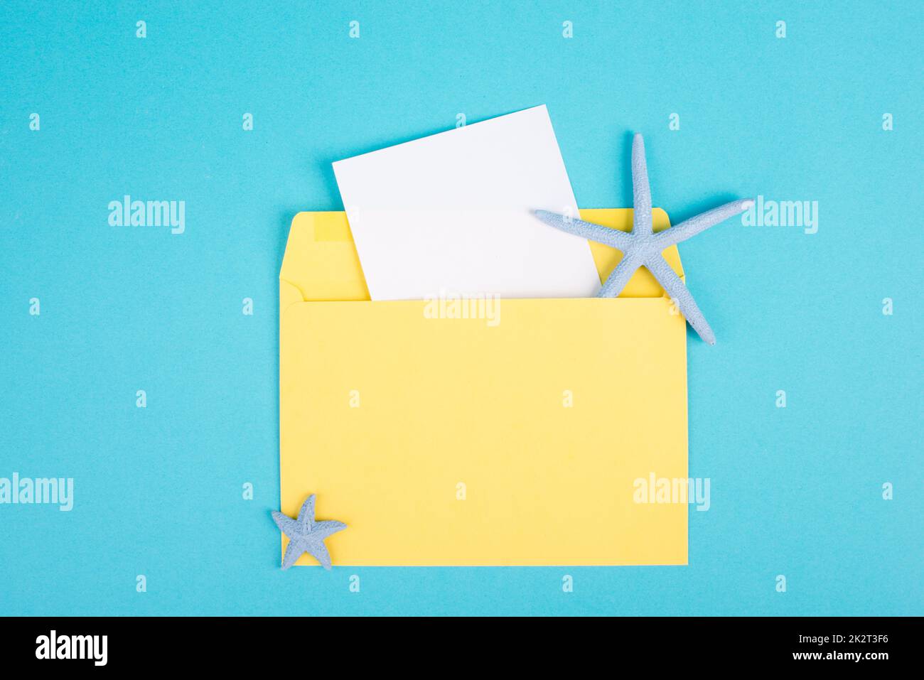 Blue colored summer and vacation background, sea star in an envelope ...