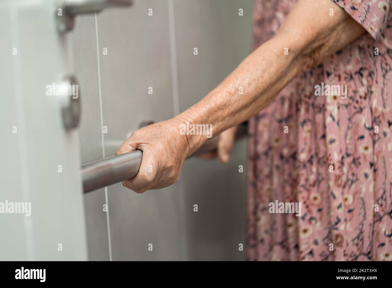 Asian senior or elderly old lady woman patient use toilet bathroom ...