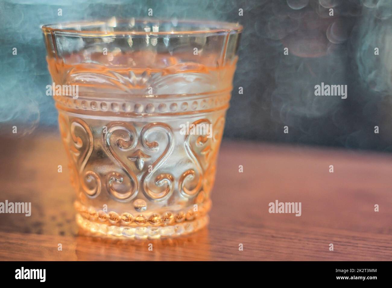 Drinking water in beautiful vintage whisky amber color glasses object ...