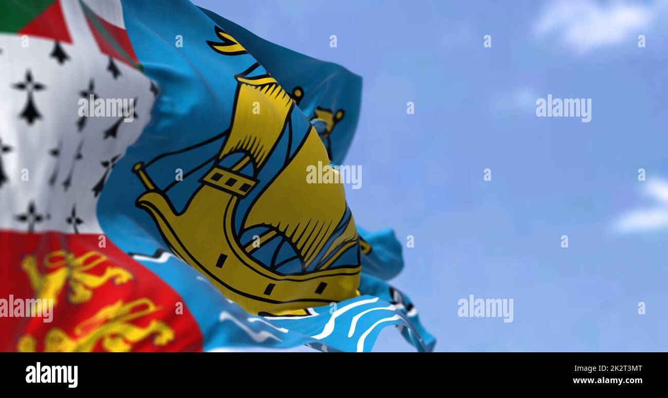 The flag of Saint Pierre and Miquelon waving in the wind on a clear day ...