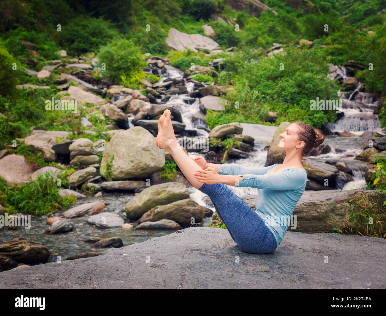Woman doing Ashtanga Vinyasa Yoga asana Navasana - boat pose Stock ...
