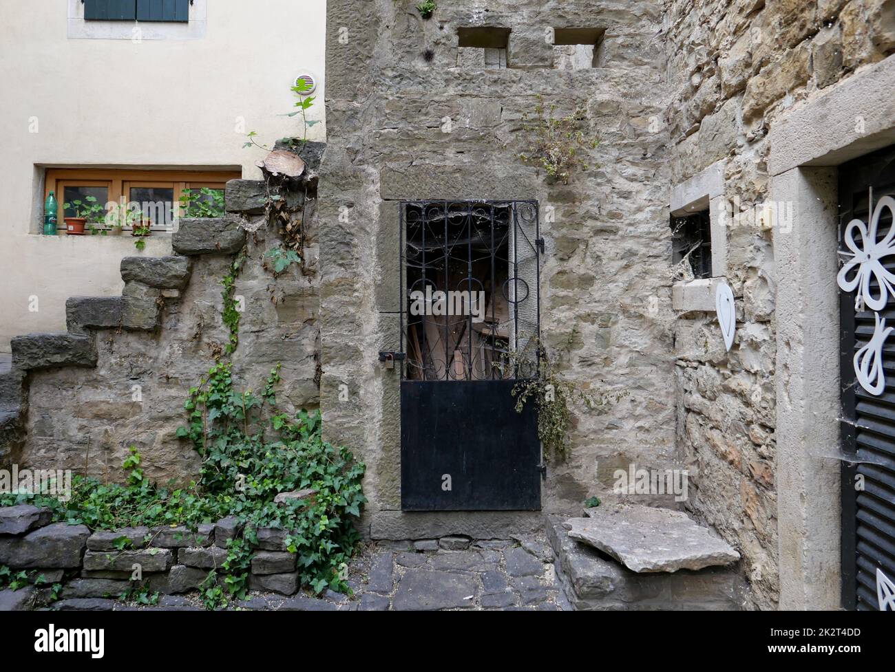 An exterior view of residential old buildings and vegetation in ... An exterior view of residential old buildings and vegetation in ...