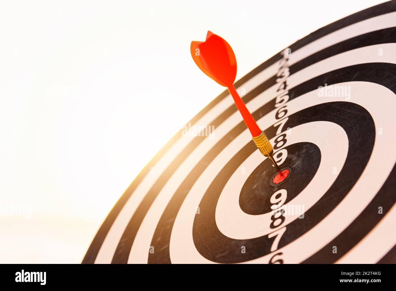 Dart arrow hit to center on bullseye of a dartboard Stock Photo - Alamy