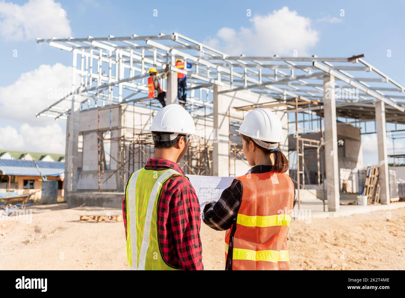 Back two architect and client discussing help create plan with ...