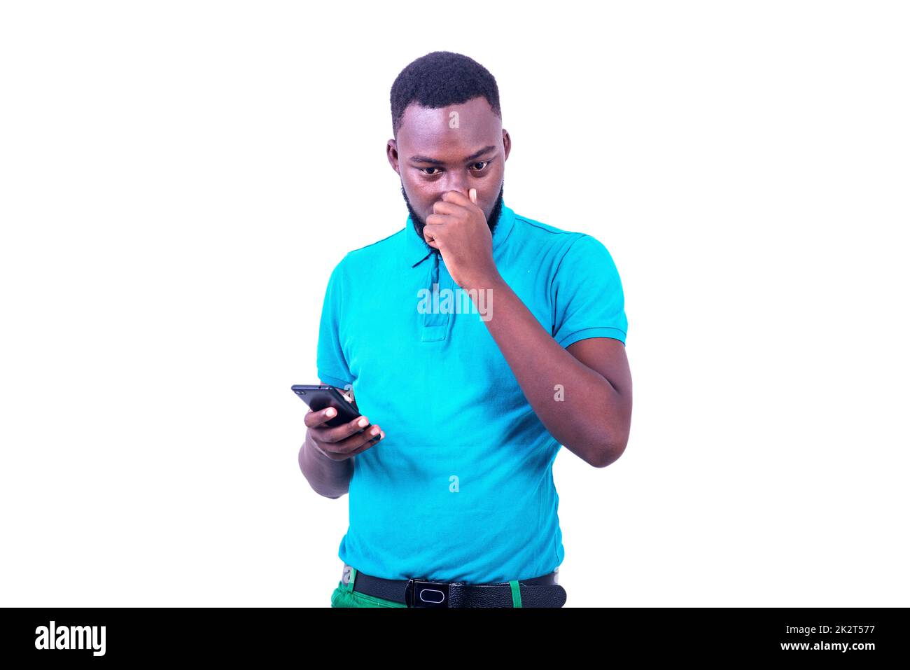 young man holding a cell phone and smelling something stinky and ...