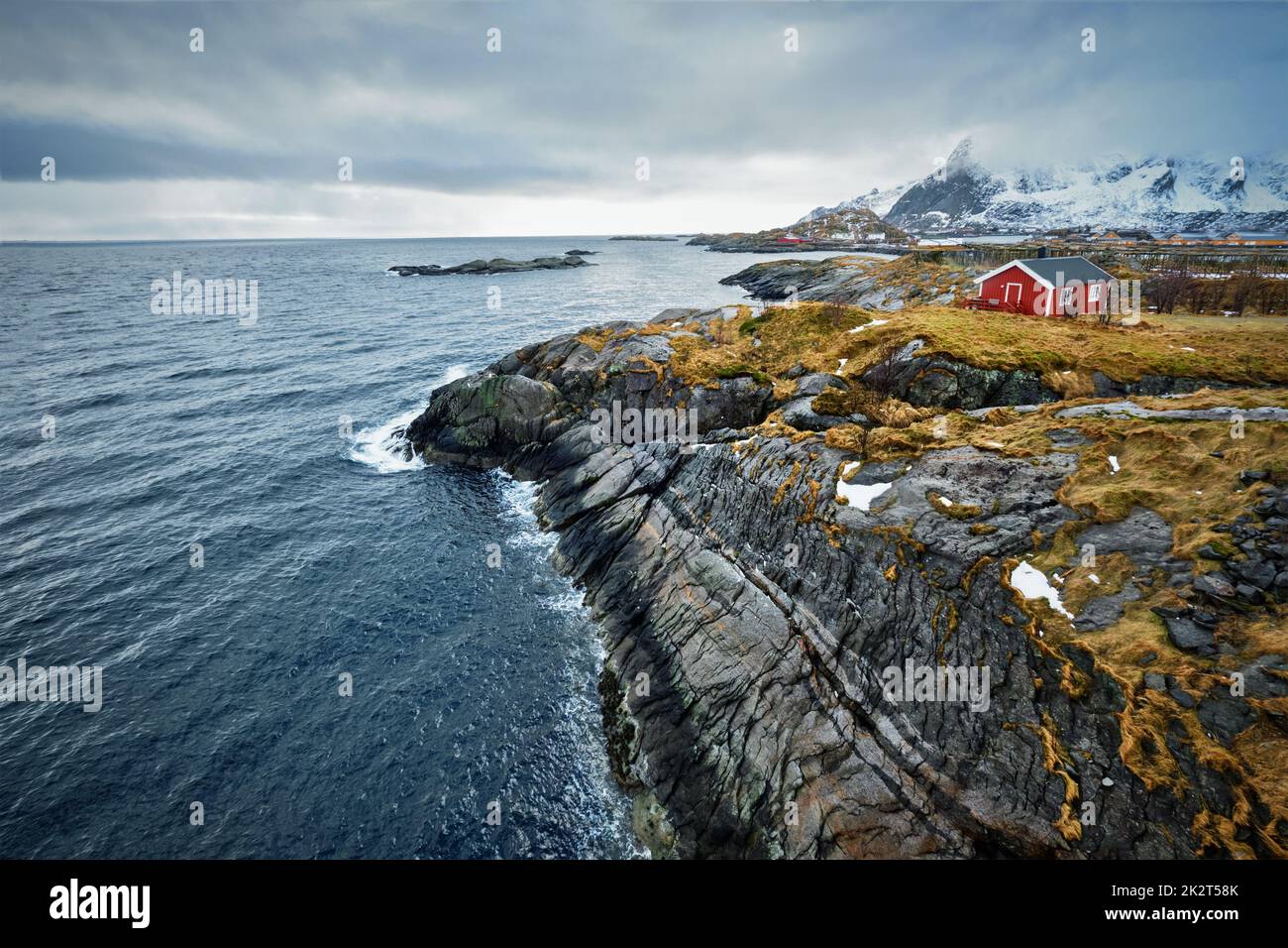Clif with traditional red rorbu house on Lofoten Islands, Norway Stock ...