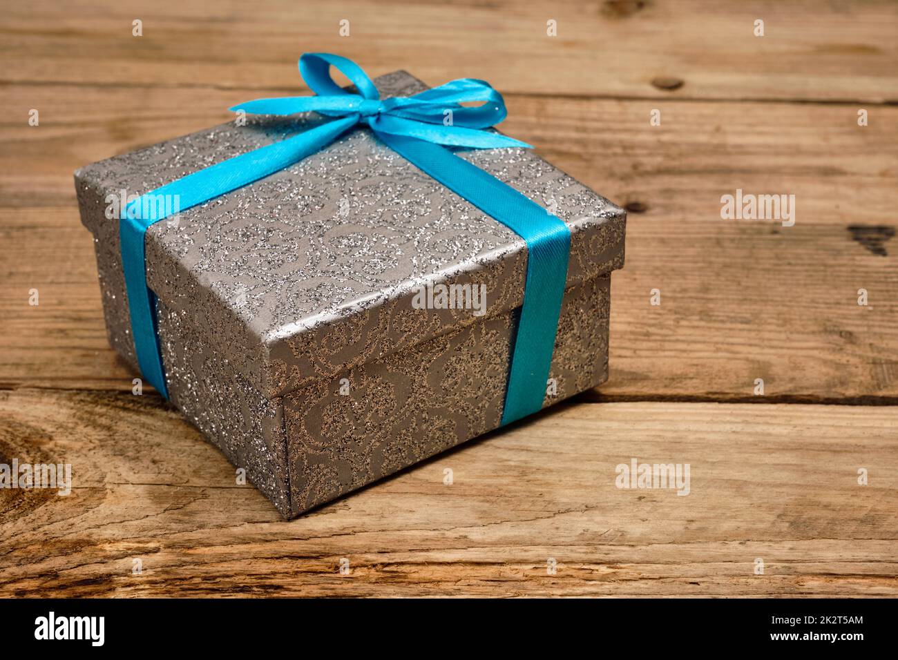 Gift box with blue ribbon Stock Photo - Alamy