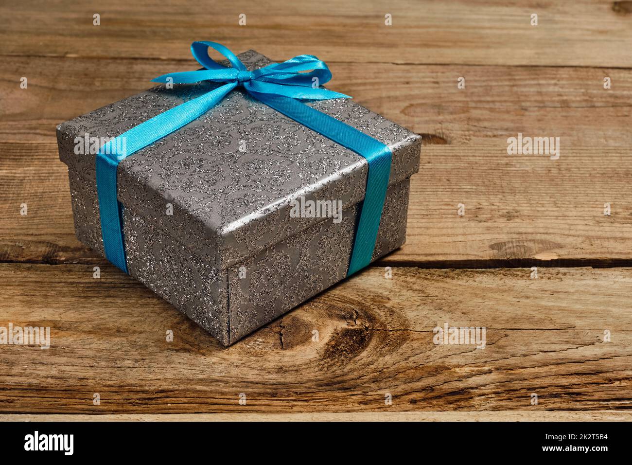 Gift box with blue ribbon Stock Photo - Alamy