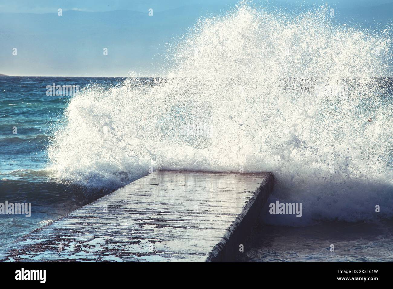 Big waves crushing on stone pier, on stormy weather Stock Photo - Alamy