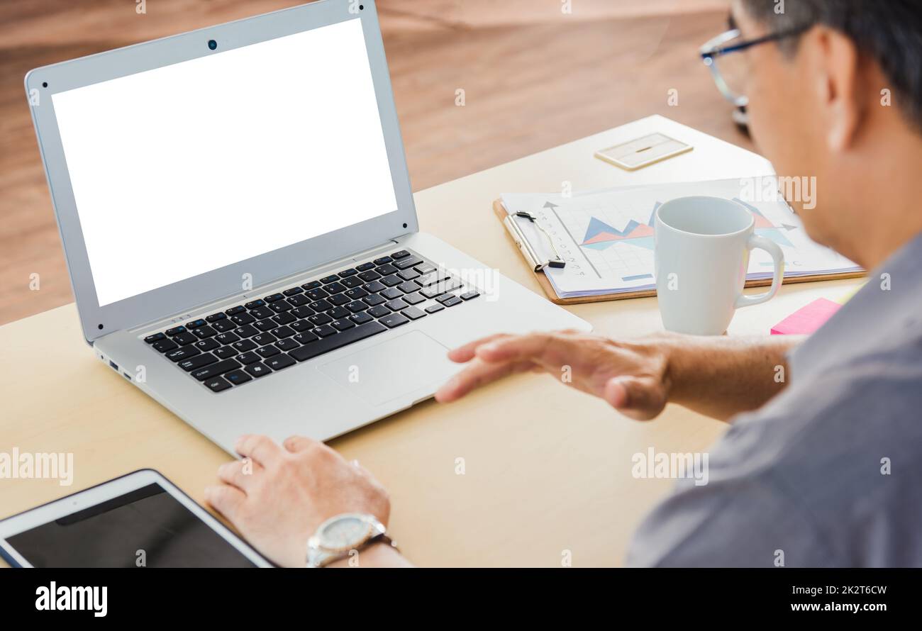 Asian senior business man working online on a modern laptop computer ...