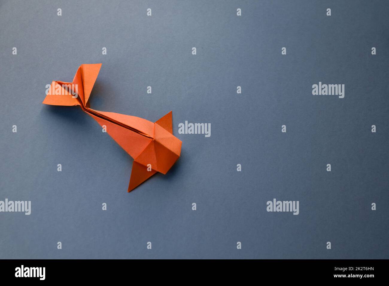 Orange paper fish origami isolated on a grey background Stock Photo - Alamy