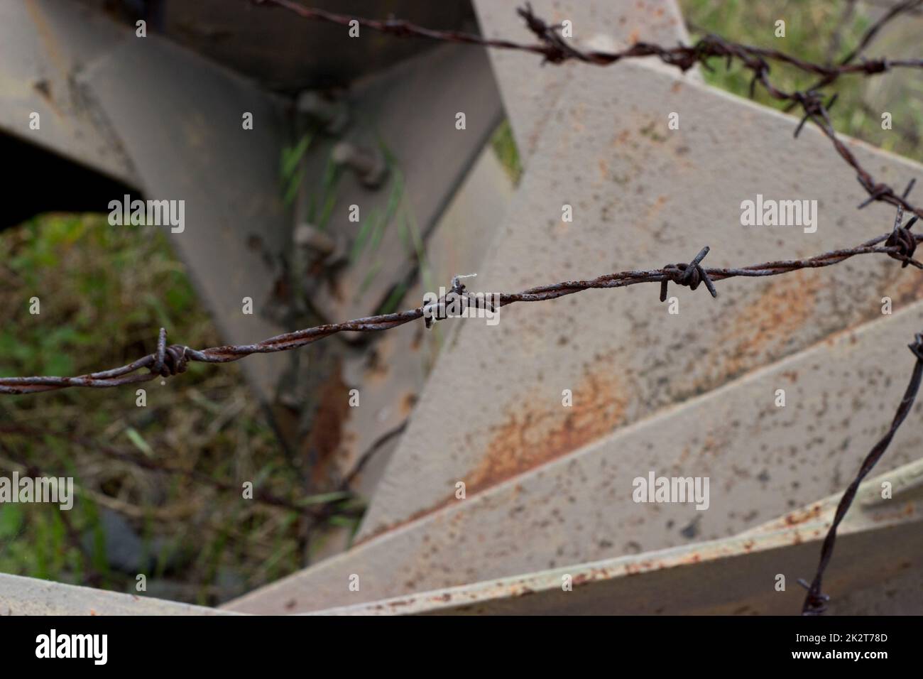 Detail hedgehod anti-tank barrier with barbed wire Stock Photo - Alamy