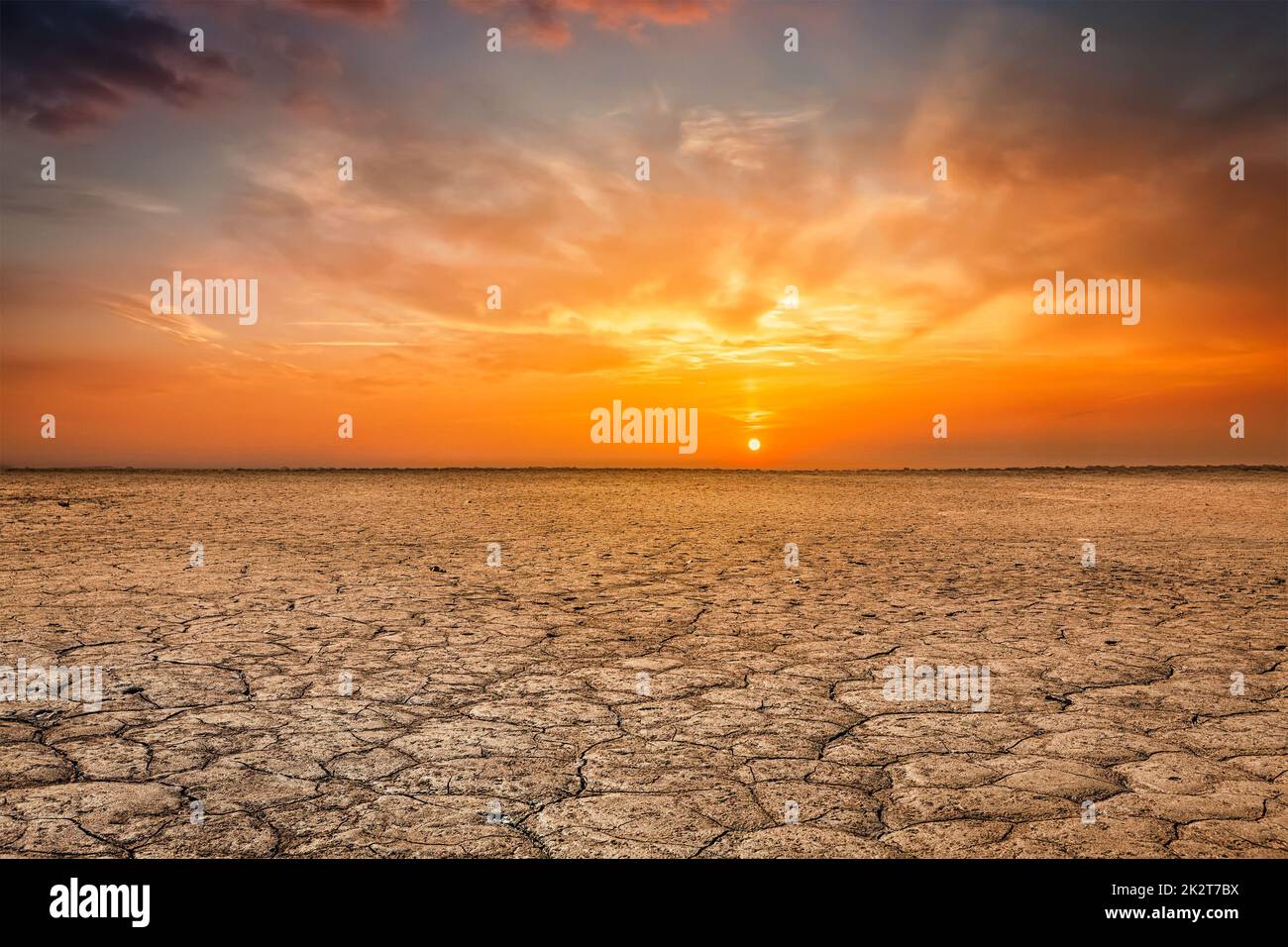 Cracked earth soil sunset landscape Stock Photo - Alamy