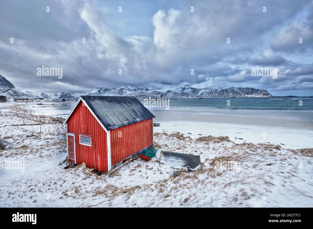 Red rorbu house shed on beach of fjord, Norway Stock Photo - Alamy