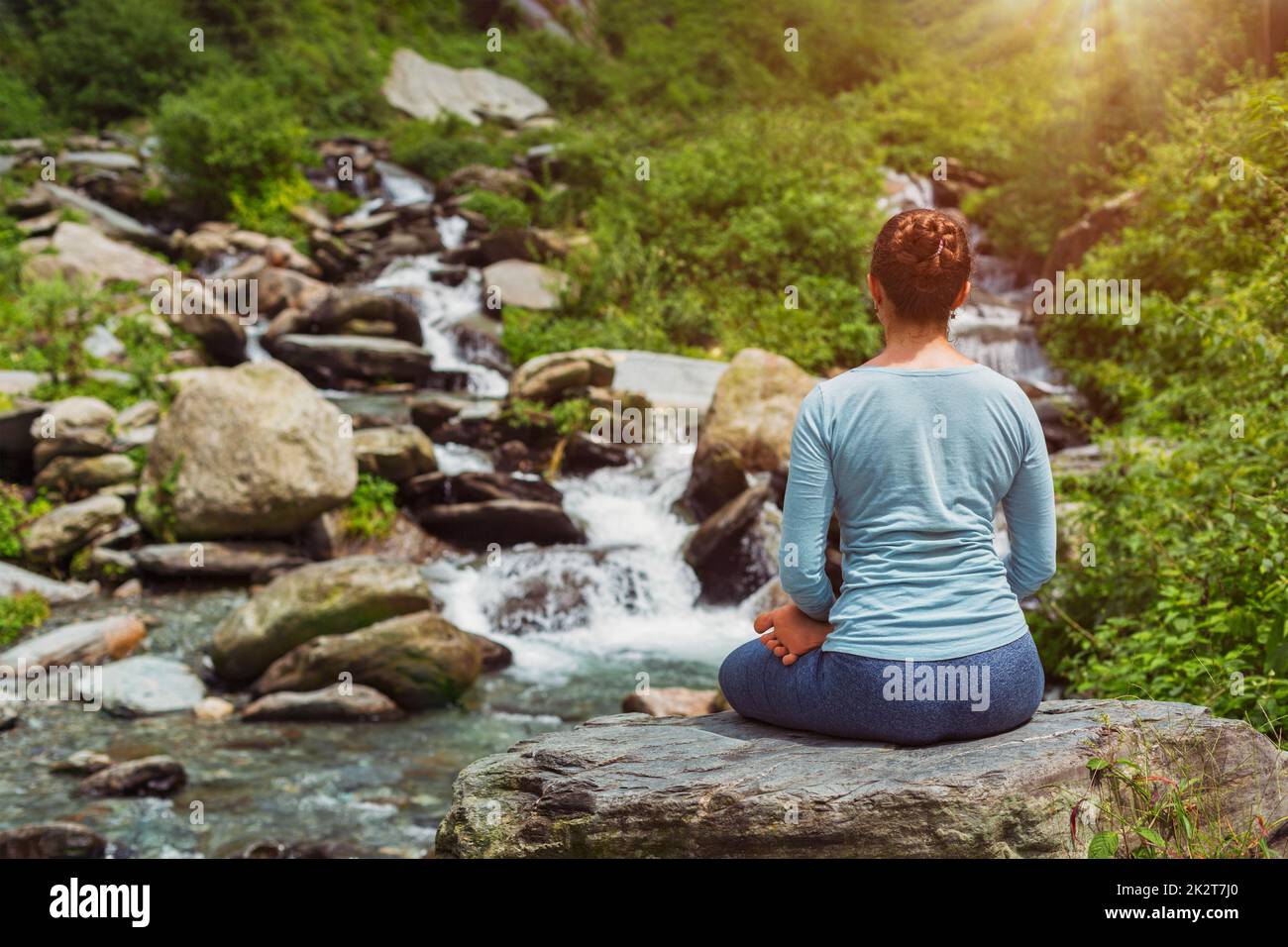 Yoga outdoors - Padmasana asana lotus pose Stock Photo - Alamy