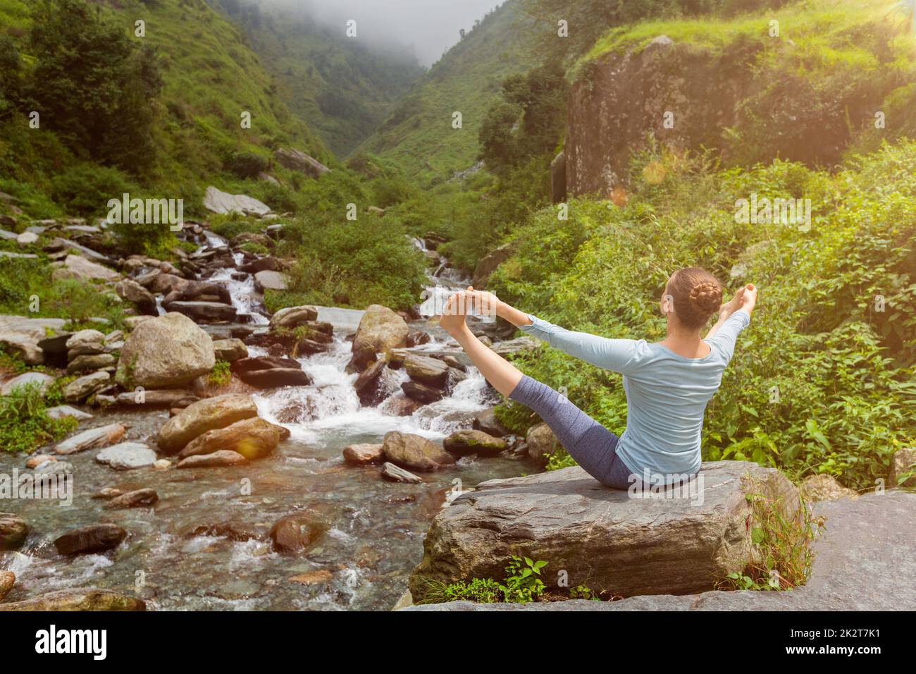 Woman doing Ashtanga Vinyasa Yoga asana outdoors Stock Photo - Alamy
