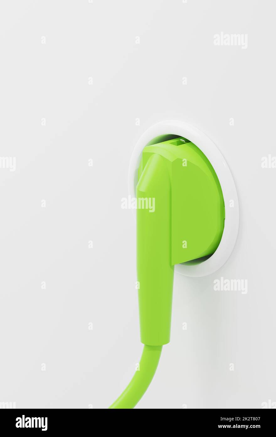 Green plug in a wall socket, green energy concept, energy transition ...
