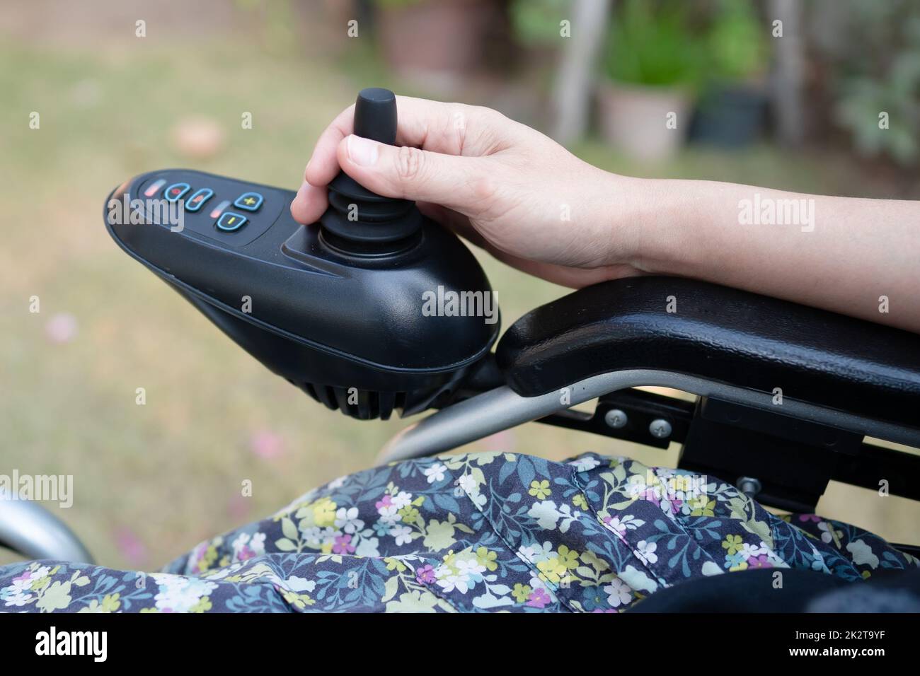 Asian lady woman patient on electric wheelchair with joystick and ...