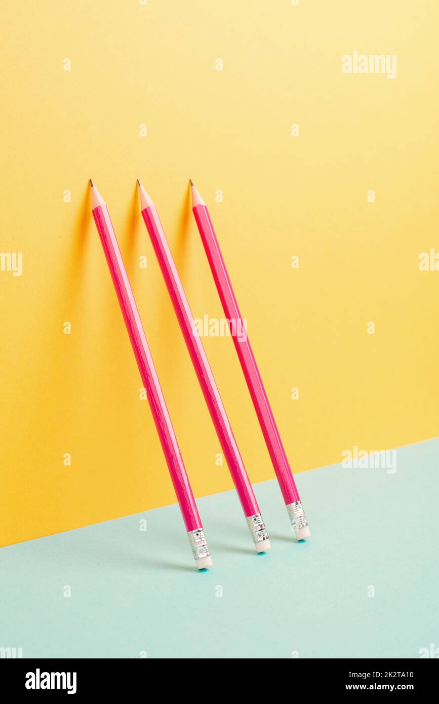 Pink pencils on a yellow and blue background, minimalism, creative ...
