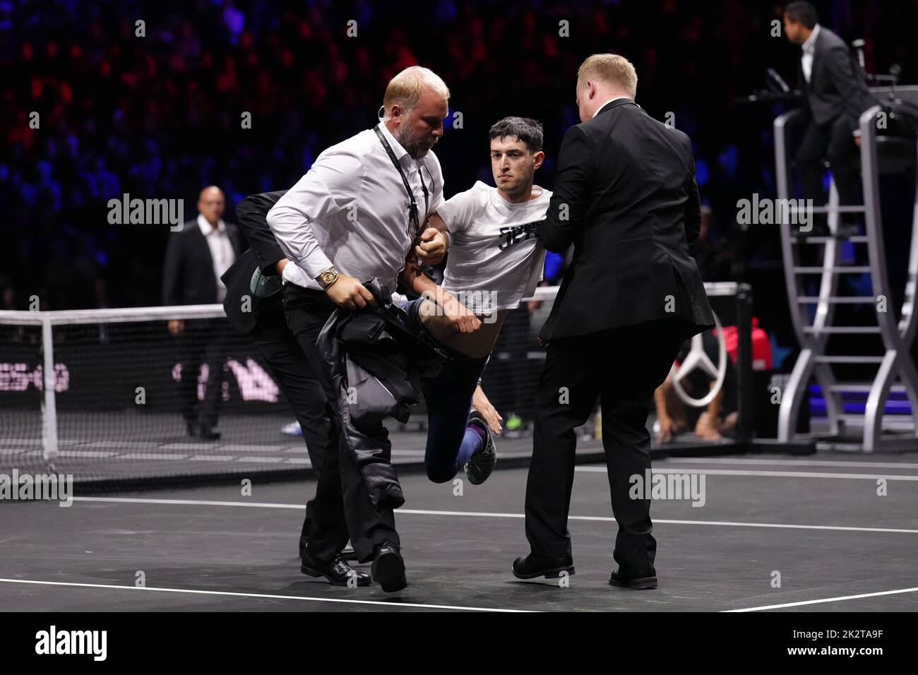 Stewards remove a protester after setting fire to the court on day one ...
