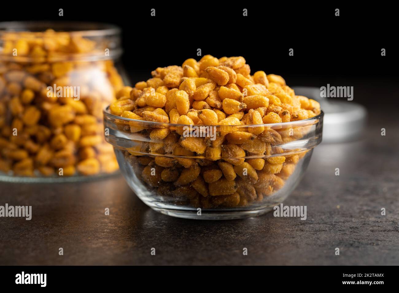 Roasted salted corn snack in bowl on black table Stock Photo - Alamy