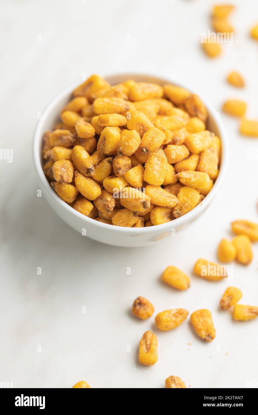 Roasted salted corn snack in bowl on white table Stock Photo - Alamy