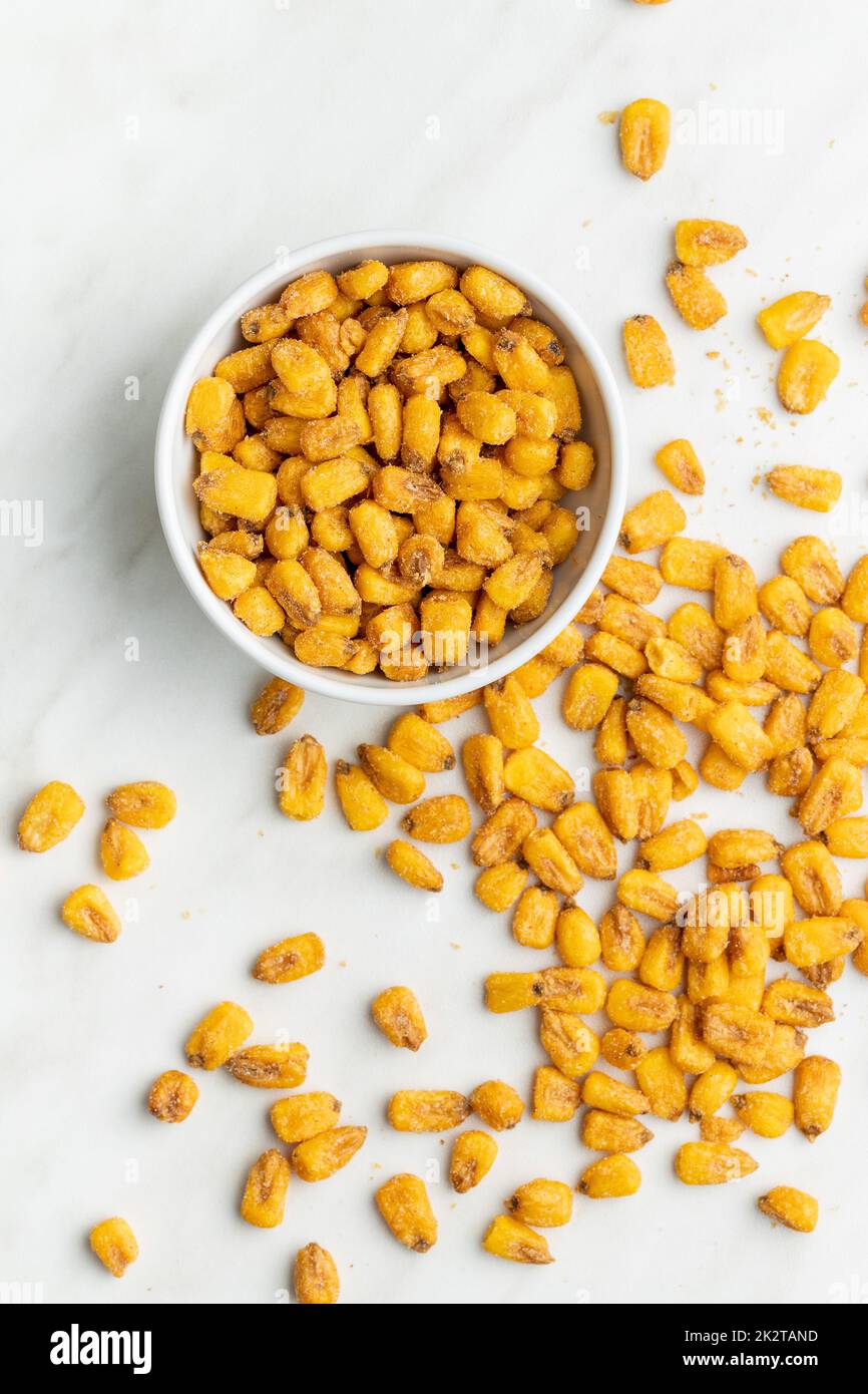 Roasted salted corn snack in bowl on white table Stock Photo - Alamy