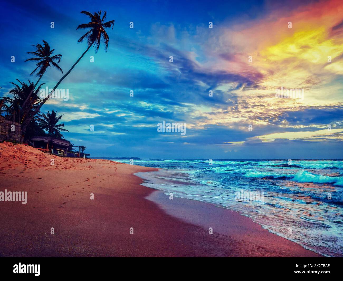 Sunset on tropical beach Stock Photo - Alamy